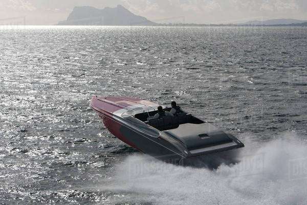 Two adult men in speedboat, Rock of Gibraltar in background, Sotogrande ...