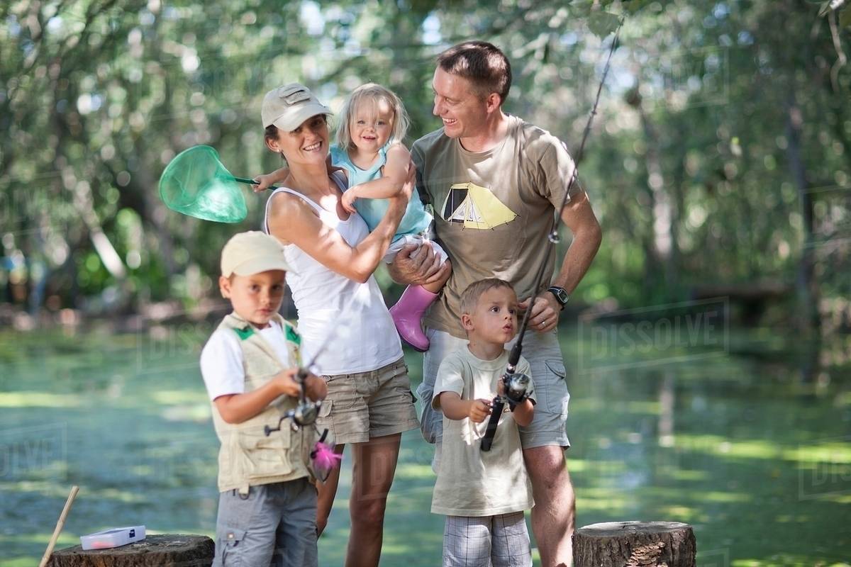 Family on fishing trip by stream - Royalty-free Stock Photo | Dissolve