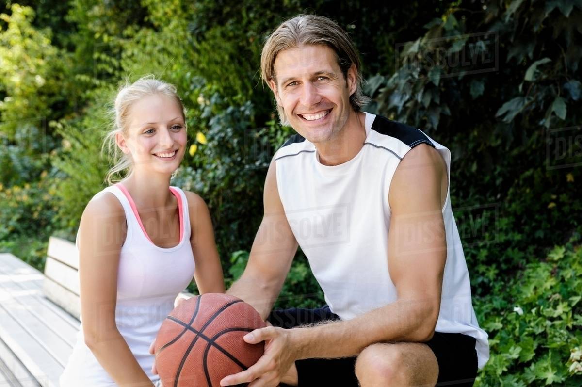 Portrait of basketball players taking a break in park - Stock Photo ...