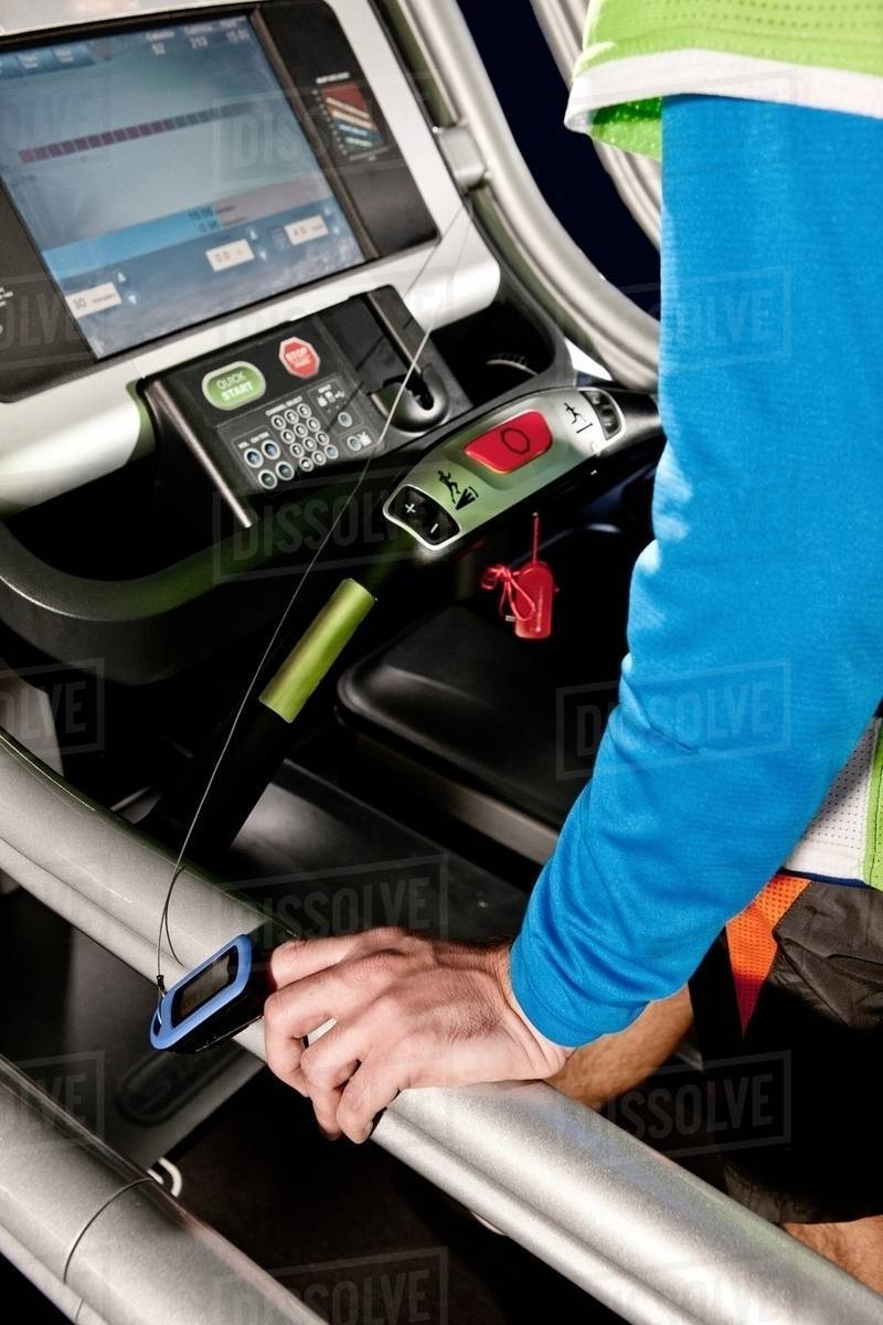 Close up of male arm and heart rate monitor on gym treadmill in ...