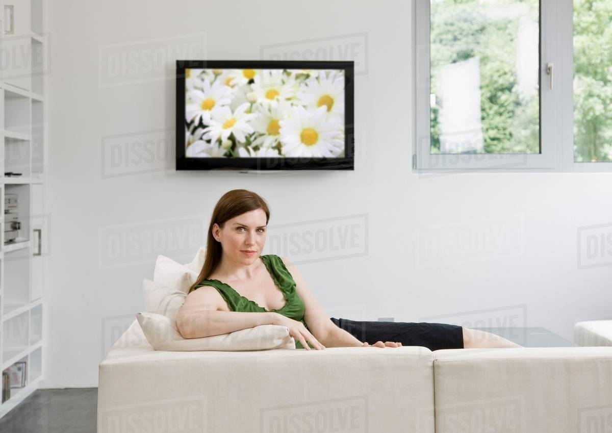 Portrait of woman laying on couch - Royalty-free Stock Photo | Dissolve