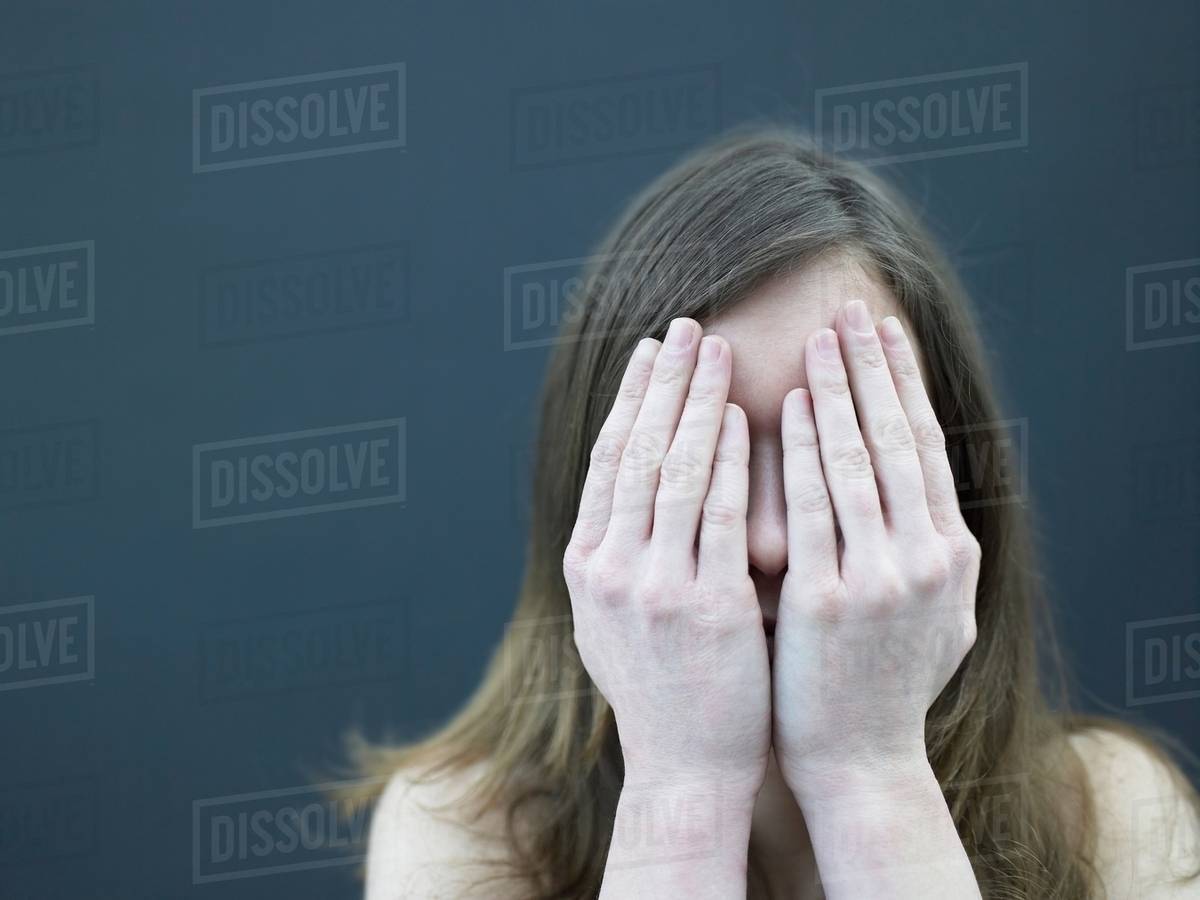 Woman with hands in front of face - Royalty-free Stock Photo | Dissolve