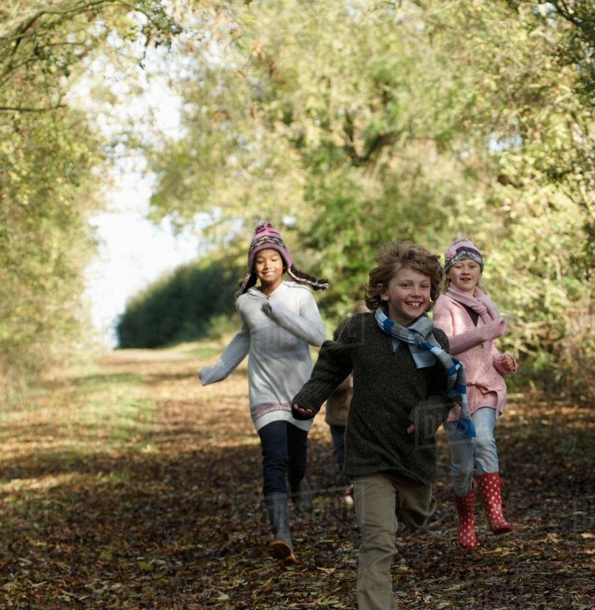 Children running down country lane - Royalty-free Stock Photo | Dissolve