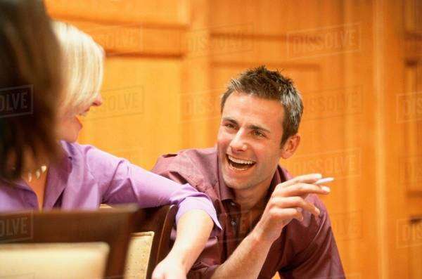 A man laughing with course mates - Stock Photo - Dissolve