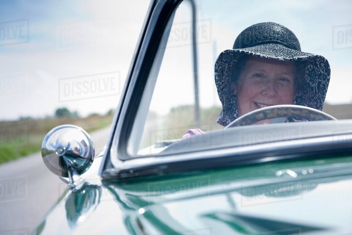 Mature lady driving car - Royalty-free Stock Photo | Dissolve