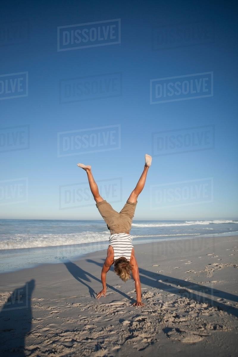 Boy doing handstand - Royalty-free Stock Photo | Dissolve