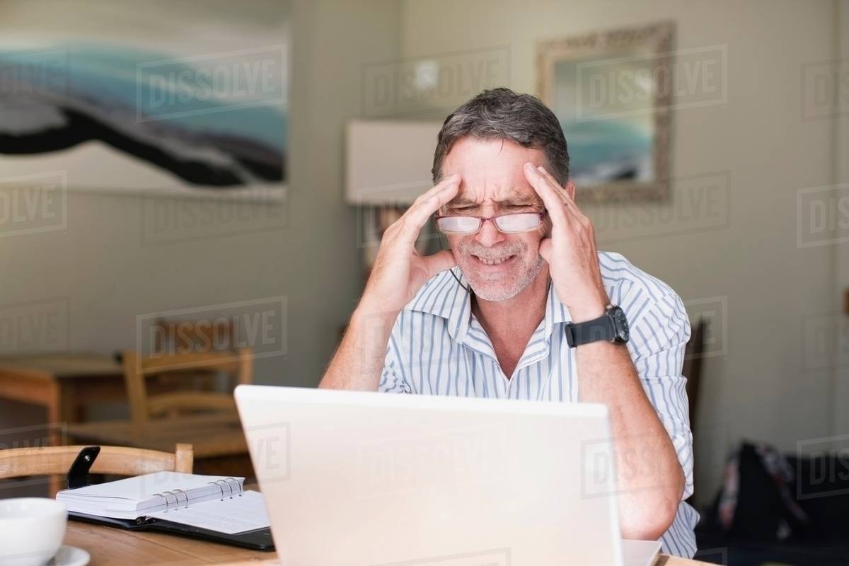 Frustrated businessman using laptop - Royalty-free Stock Photo | Dissolve