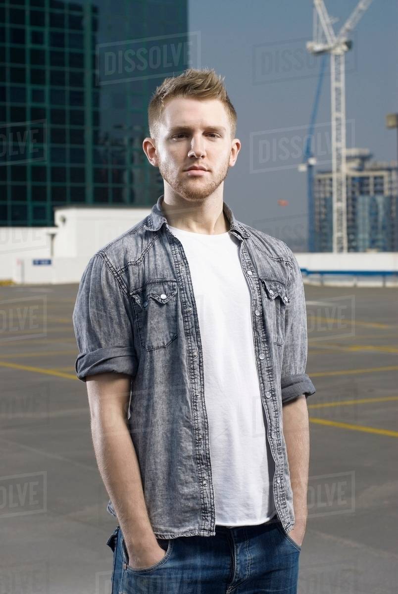 Man standing on urban rooftop - Royalty-free Stock Photo | Dissolve