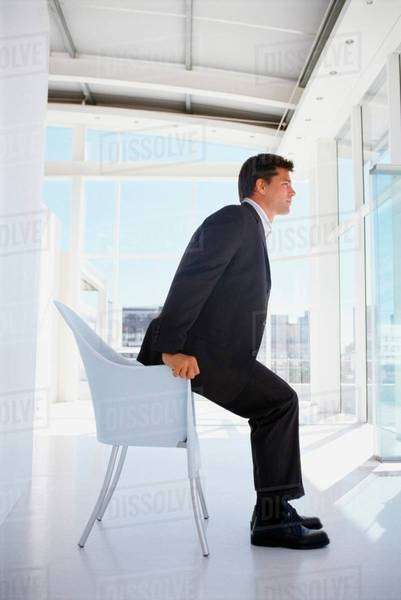 Businessman sitting in office chair - Royalty-free Stock Photo | Dissolve