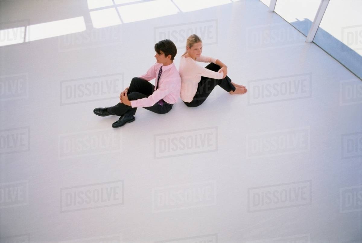 Businesspeople sitting back-to-back - Royalty-free Stock Photo | Dissolve