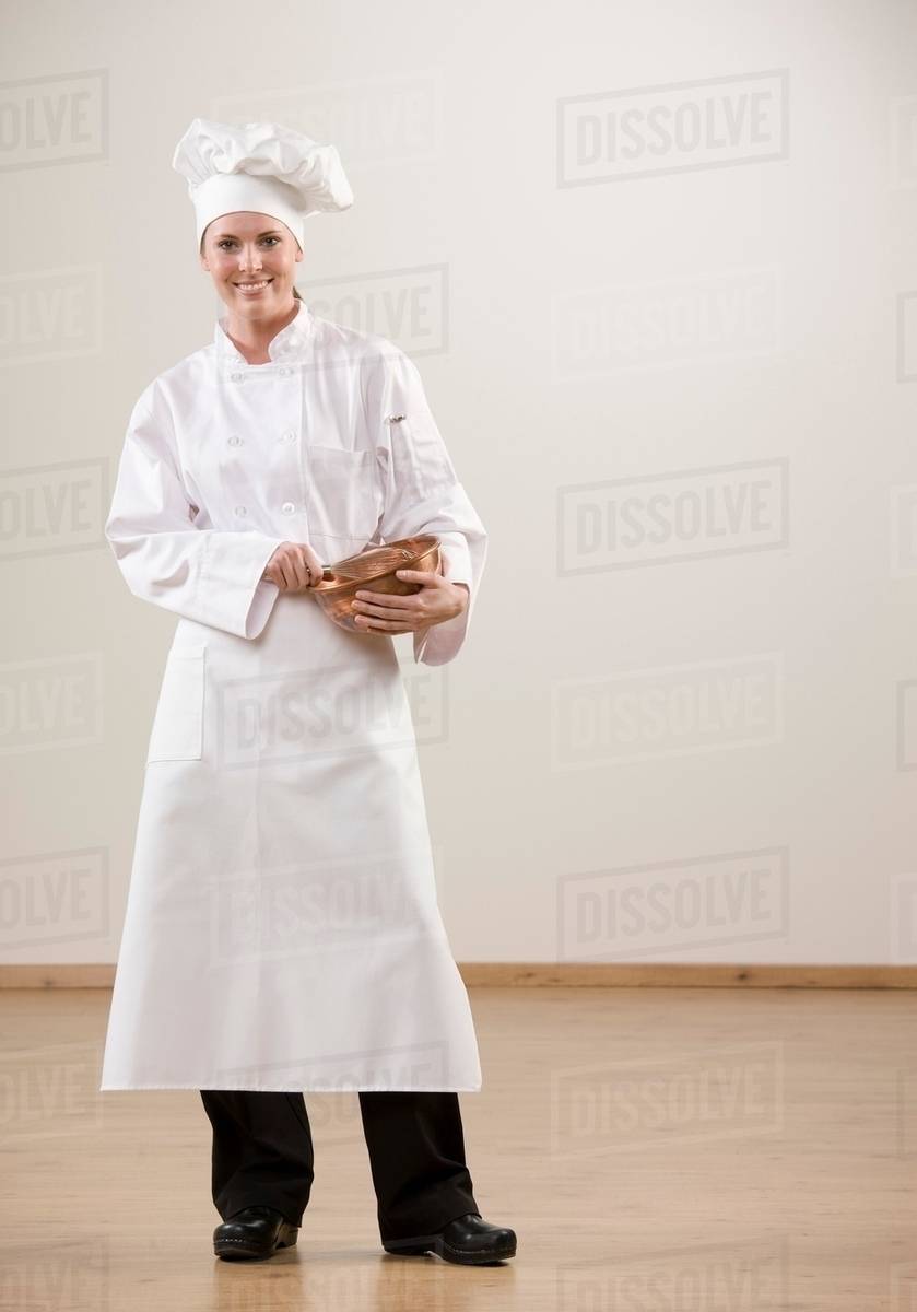 Smiling chef holding mixing bowl - Royalty-free Stock Photo | Dissolve