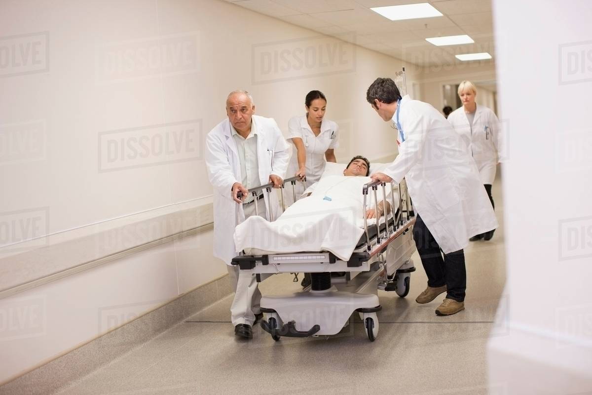 Doctors rushing patient down hallway - Royalty-free Stock Photo | Dissolve