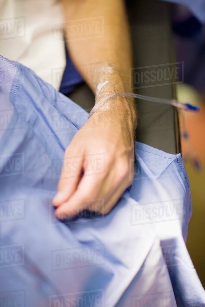 Patient with intravenous drip in arm - Royalty-free Stock Photo | Dissolve