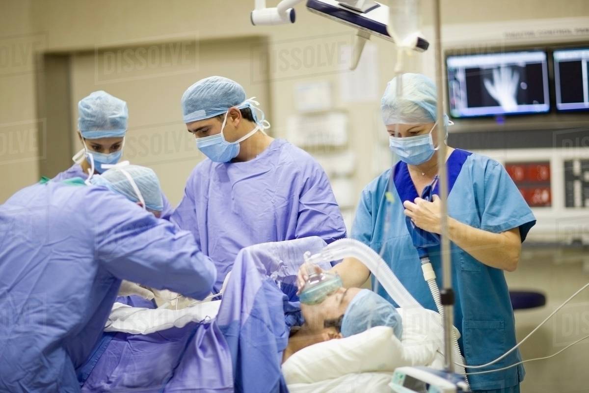 Doctor and nurses performing operation - Royalty-free Stock Photo ...