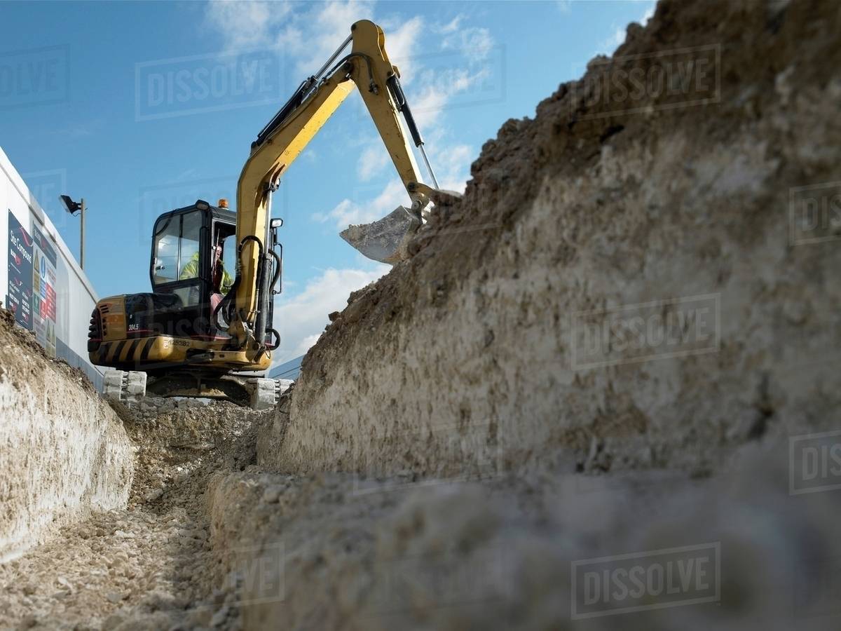 Digger at construction site - Royalty-free Stock Photo | Dissolve