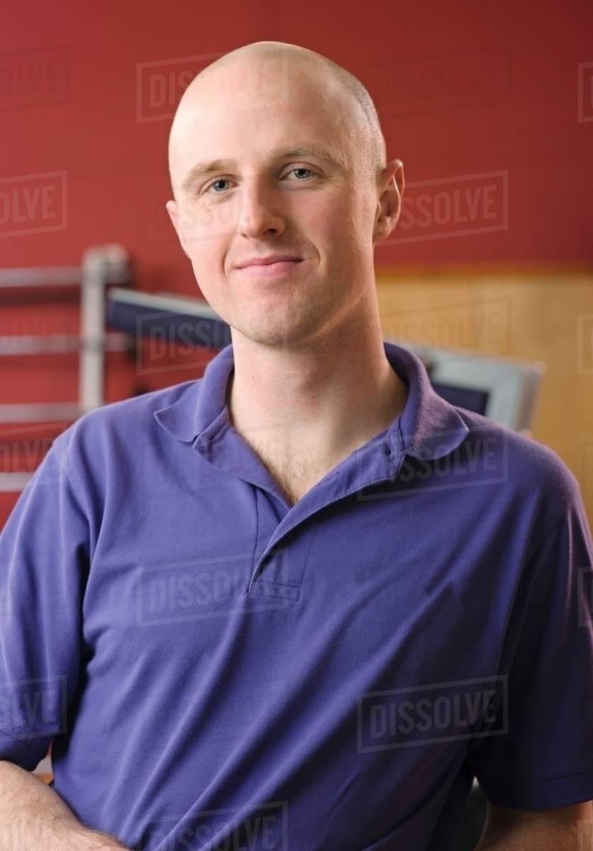 Trainer smiling in gym - Royalty-free Stock Photo | Dissolve