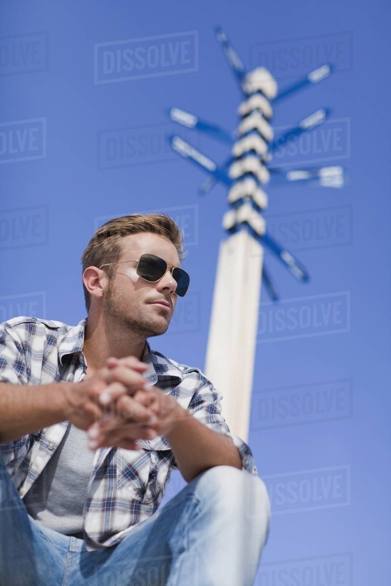 Man sitting at crossroads - Royalty-free Stock Photo | Dissolve