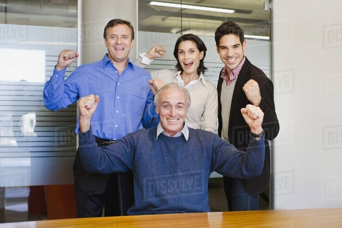 Business people cheering in office - Royalty-free Stock Photo | Dissolve