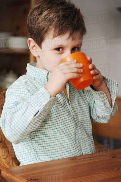 Boy drinking out of plastic cup - Stock Photo - Dissolve