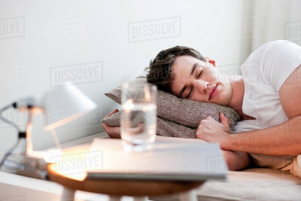 Man asleep in bed - Royalty-free Stock Photo | Dissolve
