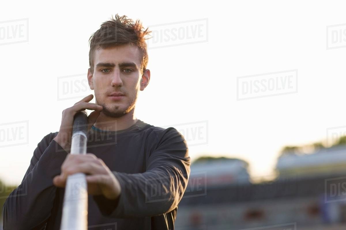 Man carrying pole outdoors - Royalty-free Stock Photo | Dissolve