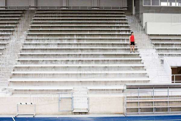 Man standing on stadium steps - Royalty-free Stock Photo | Dissolve