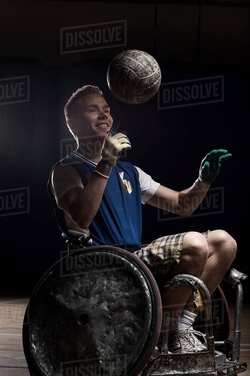 Rugby player in wheelchair with ball - Stock Photo - Dissolve