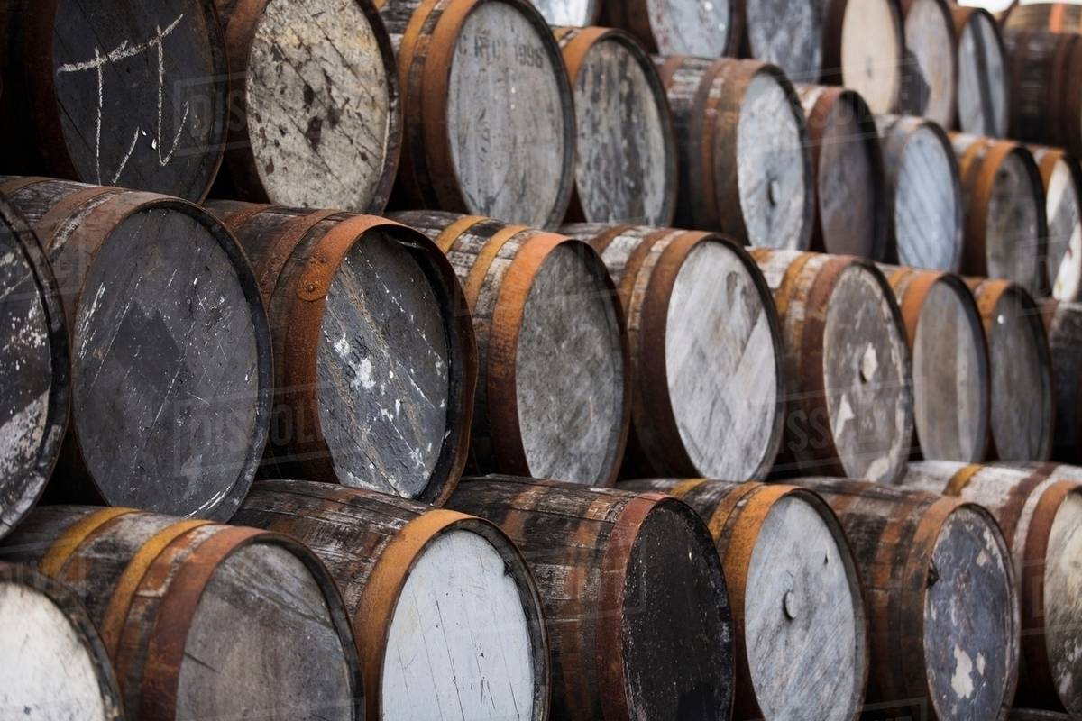 Stack of wooden whisky casks - Royalty-free Stock Photo | Dissolve
