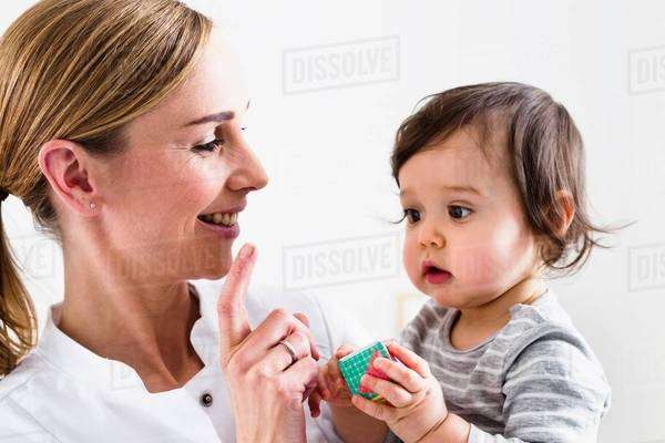 Paediatrician doing assessment of baby boy - Stock Photo - Dissolve