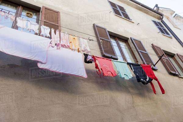 Clothes hanging on line from windows - Stock Photo - Dissolve