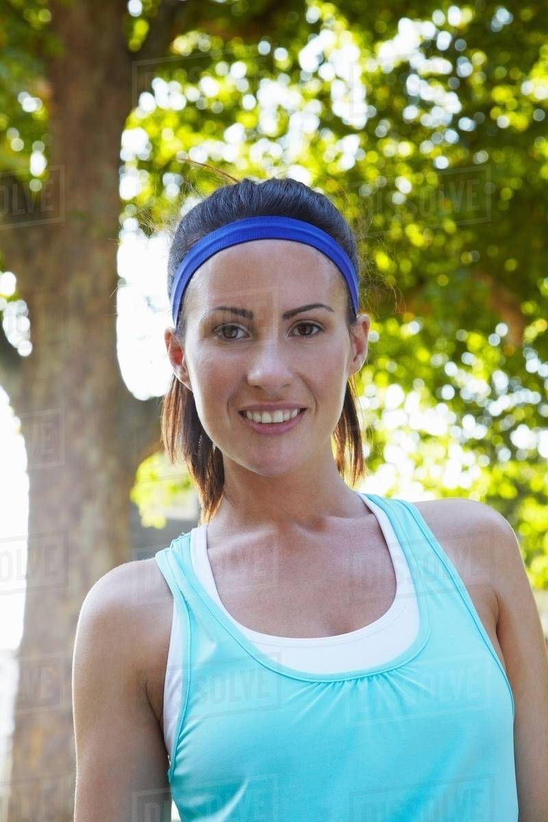 Woman smiling outdoors - Stock Photo - Dissolve