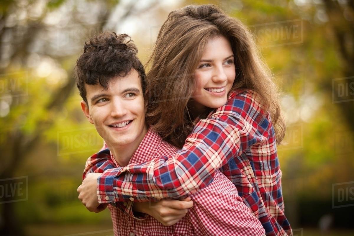 Teenage couple hugging in park - Royalty-free Stock Photo | Dissolve