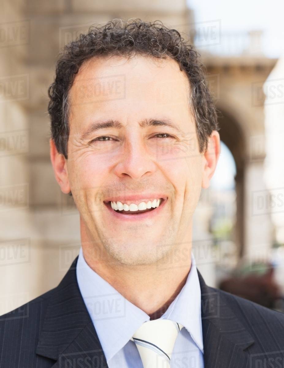 Close up of businessman's smiling face - Stock Photo - Dissolve