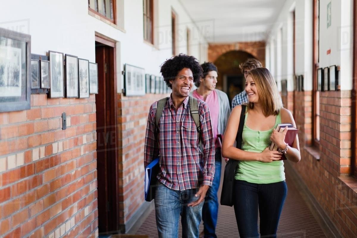 Students walking together in hallway - Royalty-free Stock Photo | Dissolve