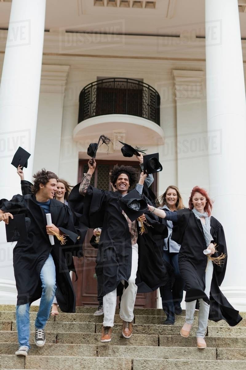 Graduates cheering on campus - Stock Photo - Dissolve