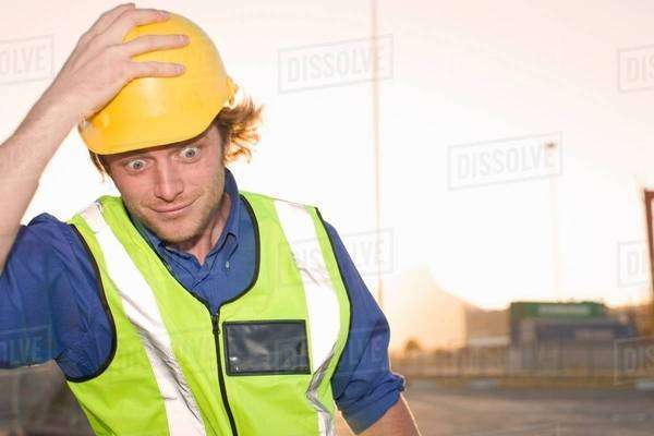 Construction worker wearing hard hat - Stock Photo - Dissolve