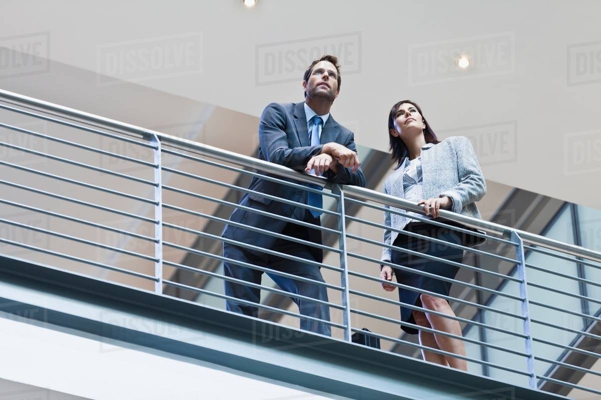 Business people talking on balcony - Stock Photo - Dissolve
