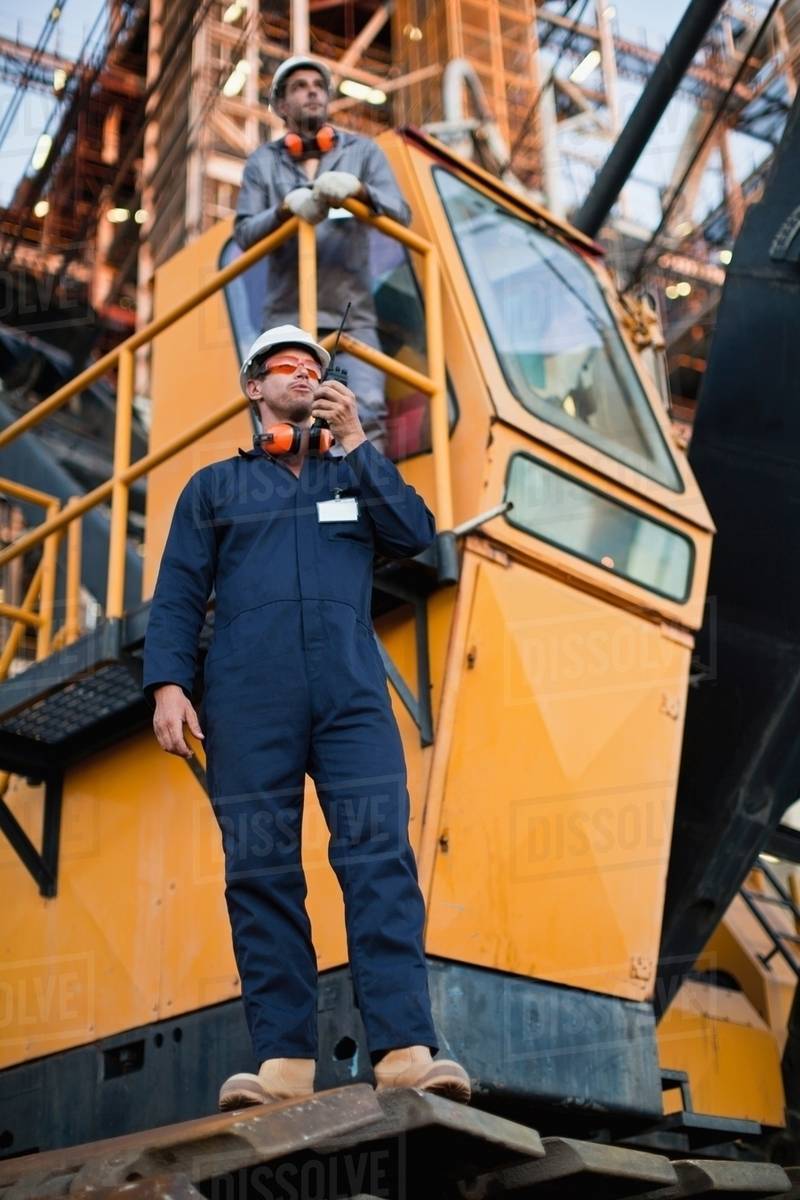Worker using walkie talkie on site - Royalty-free Stock Photo | Dissolve