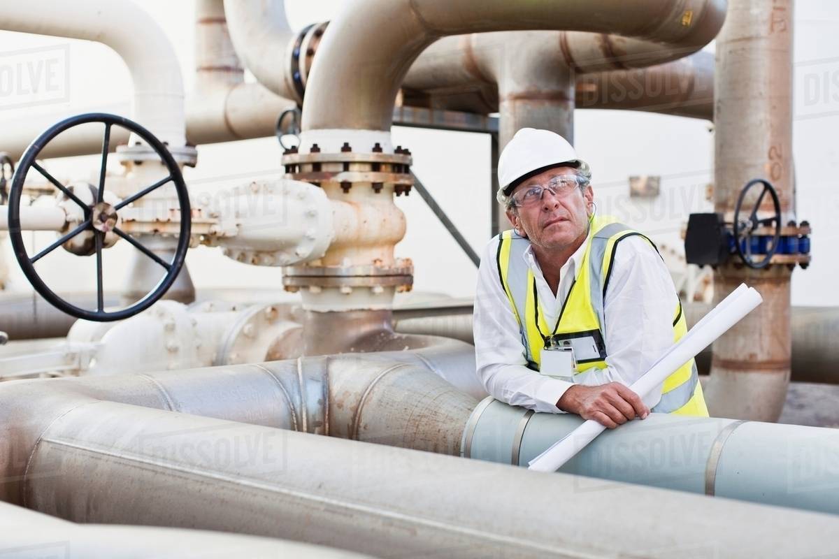 Worker on pipes at chemical plant - Royalty-free Stock Photo | Dissolve