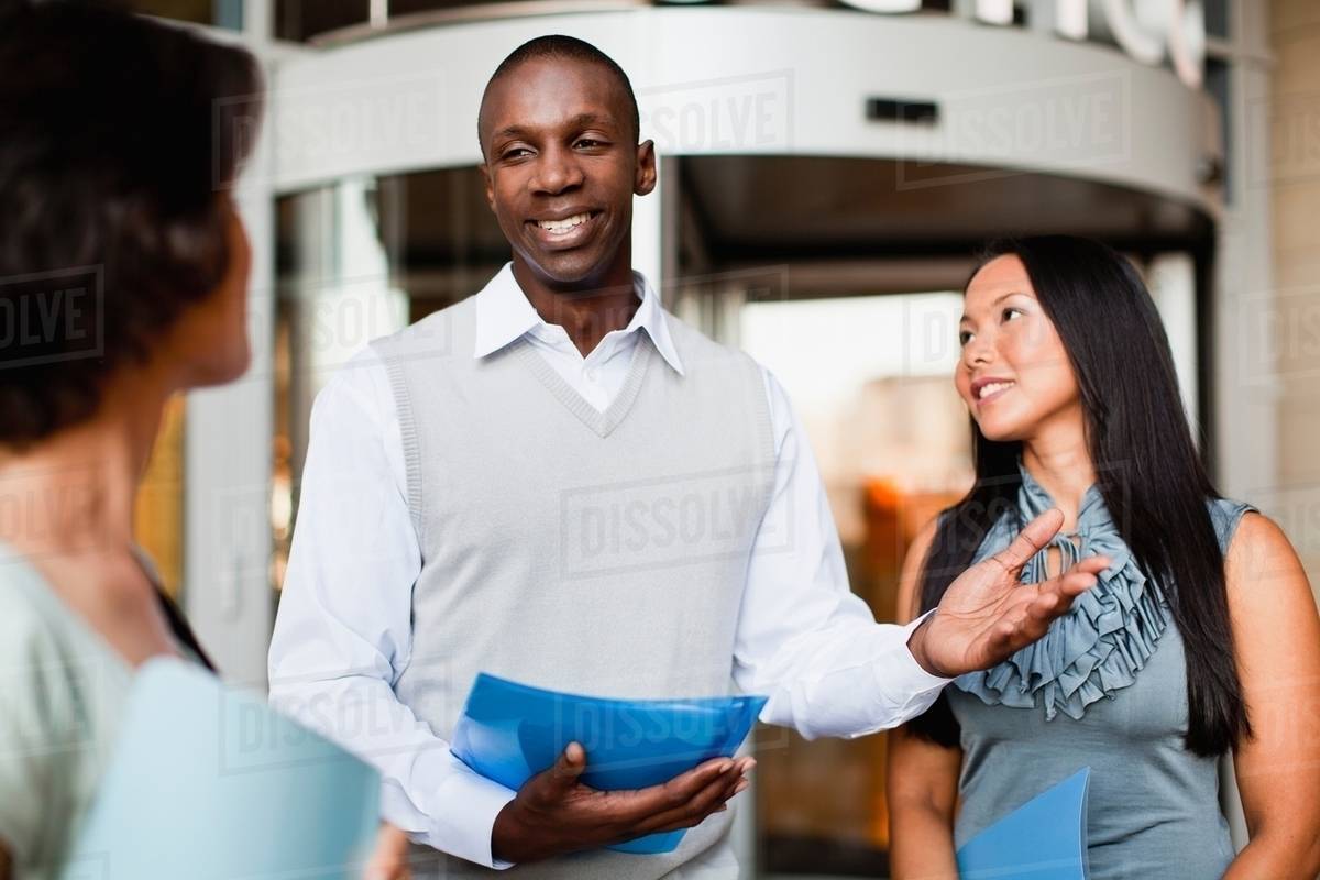 Business people talking outside building - Royalty-free Stock Photo ...