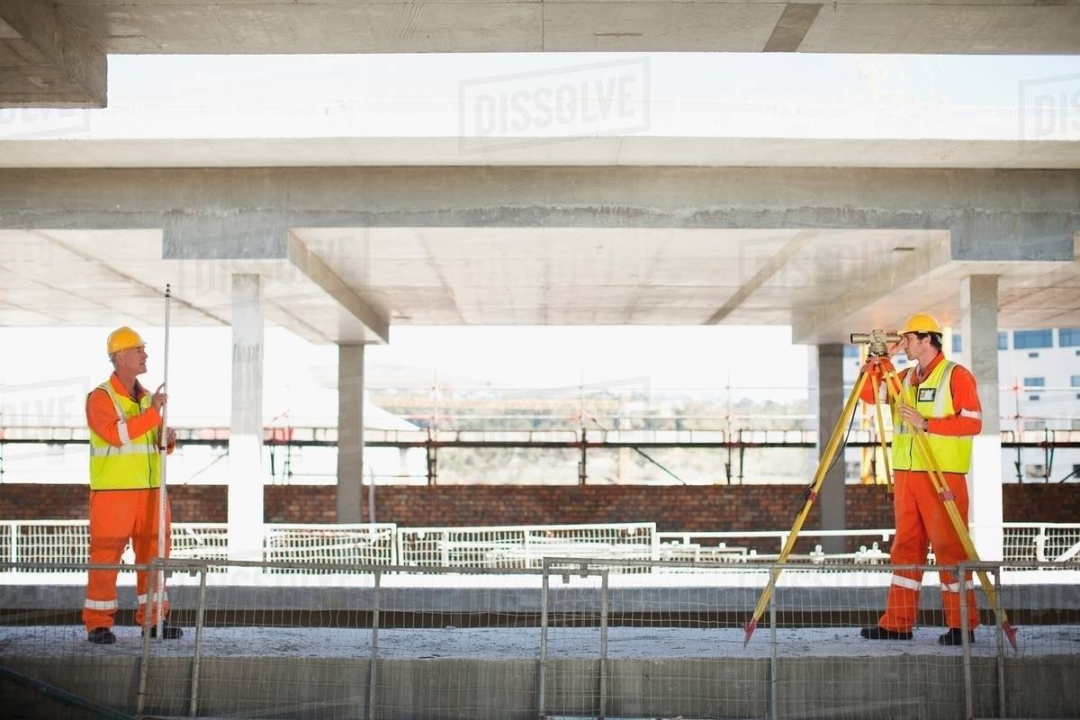 Workers using equipment on site - Royalty-free Stock Photo | Dissolve