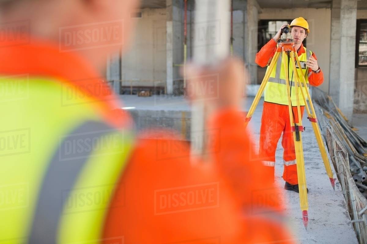 Workers using equipment on site - Royalty-free Stock Photo | Dissolve