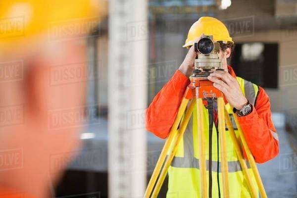 Workers using equipment on site - Royalty-free Stock Photo | Dissolve