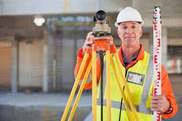 Worker using equipment on site - Stock Photo - Dissolve