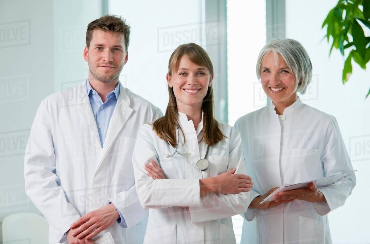 Doctors smiling together in hospital - Royalty-free Stock Photo | Dissolve