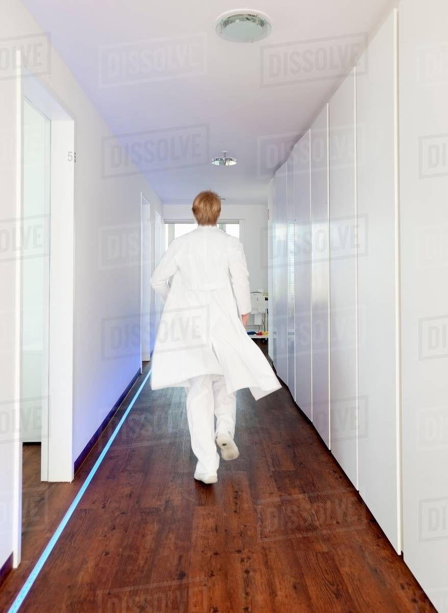 Doctor walking in hallway - Stock Photo - Dissolve