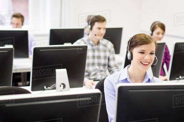 Business people working in headsets - Stock Photo - Dissolve