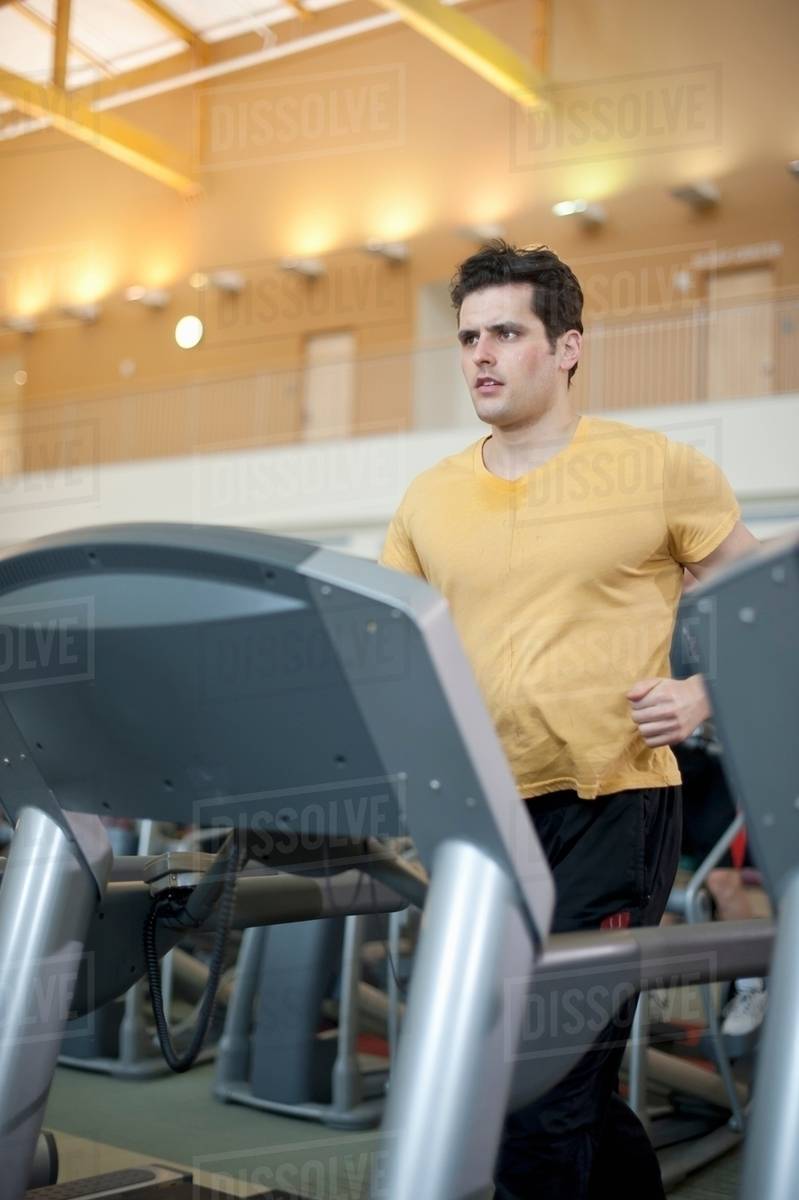 Man using treadmill in gym - Royalty-free Stock Photo | Dissolve