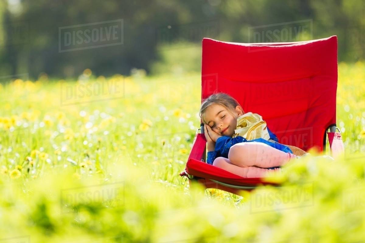 Girl in costume sleeping in chair - Royalty-free Stock Photo | Dissolve