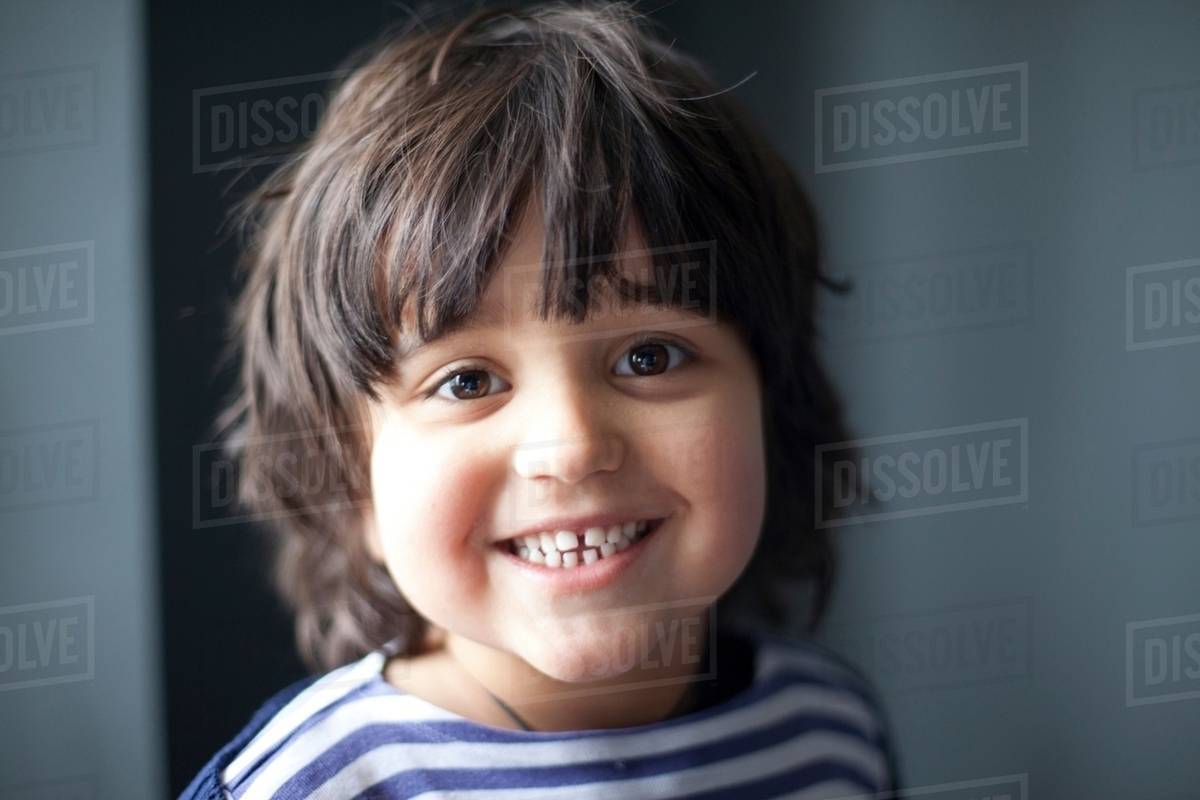 Close up of smiling boys face - Stock Photo - Dissolve